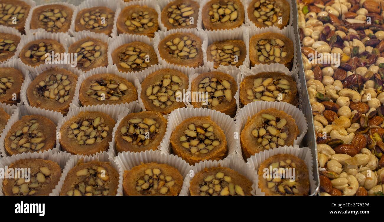 Turkish traditional dessert Kadayif baked in syrup served with nut ...