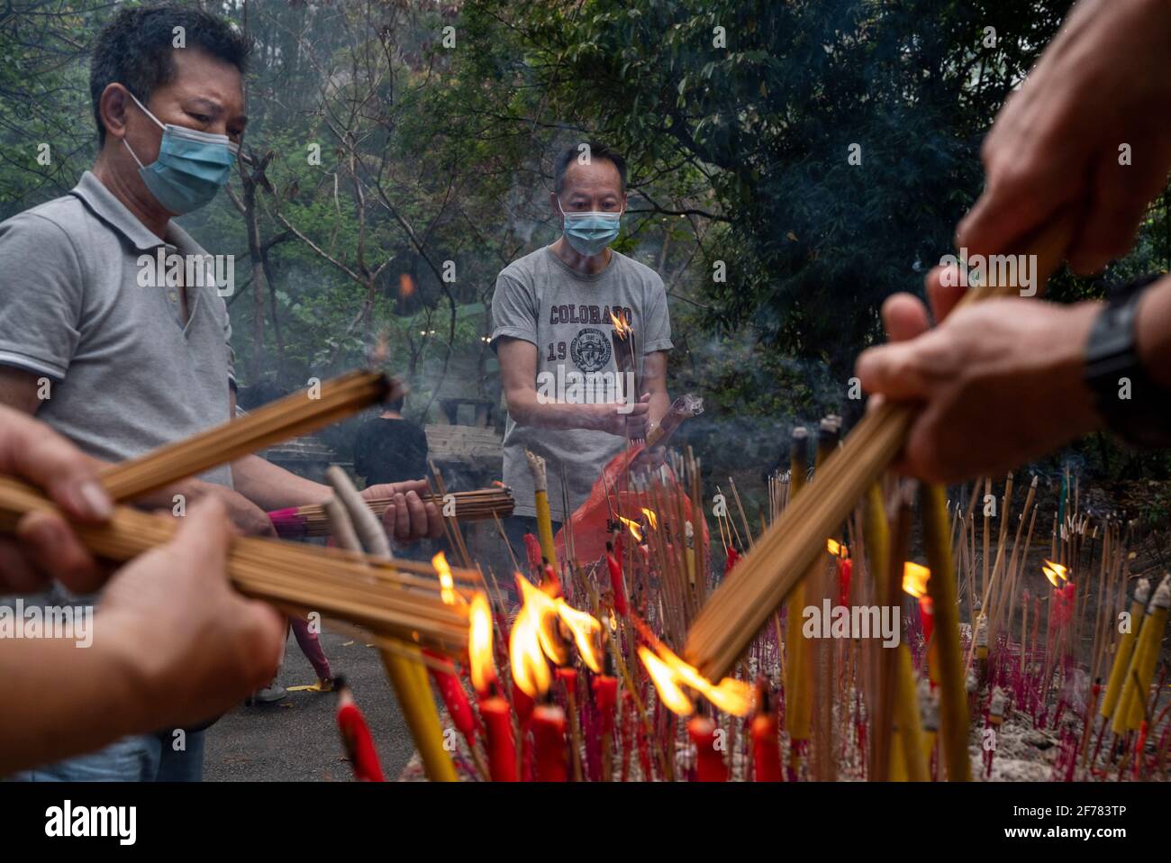 People burn incense at a cemetery during the Ching Ming Festival in ...