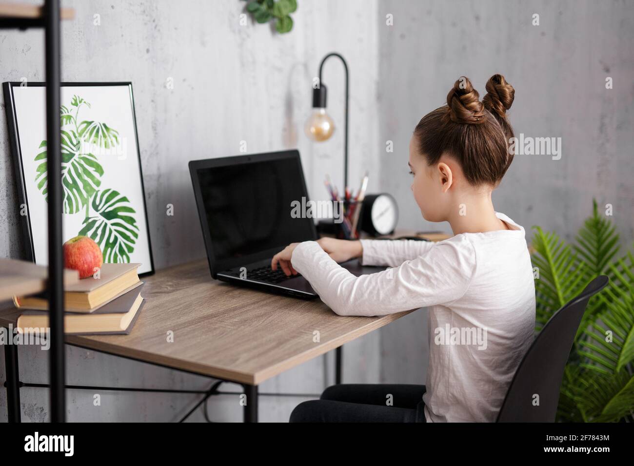 back view of cute girl using laptop and studying at home Stock Photo ...