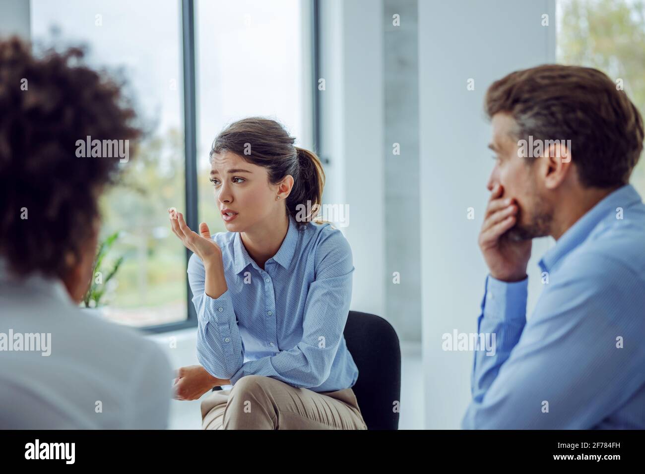 Support group of business people sitting in circle and talking about ...