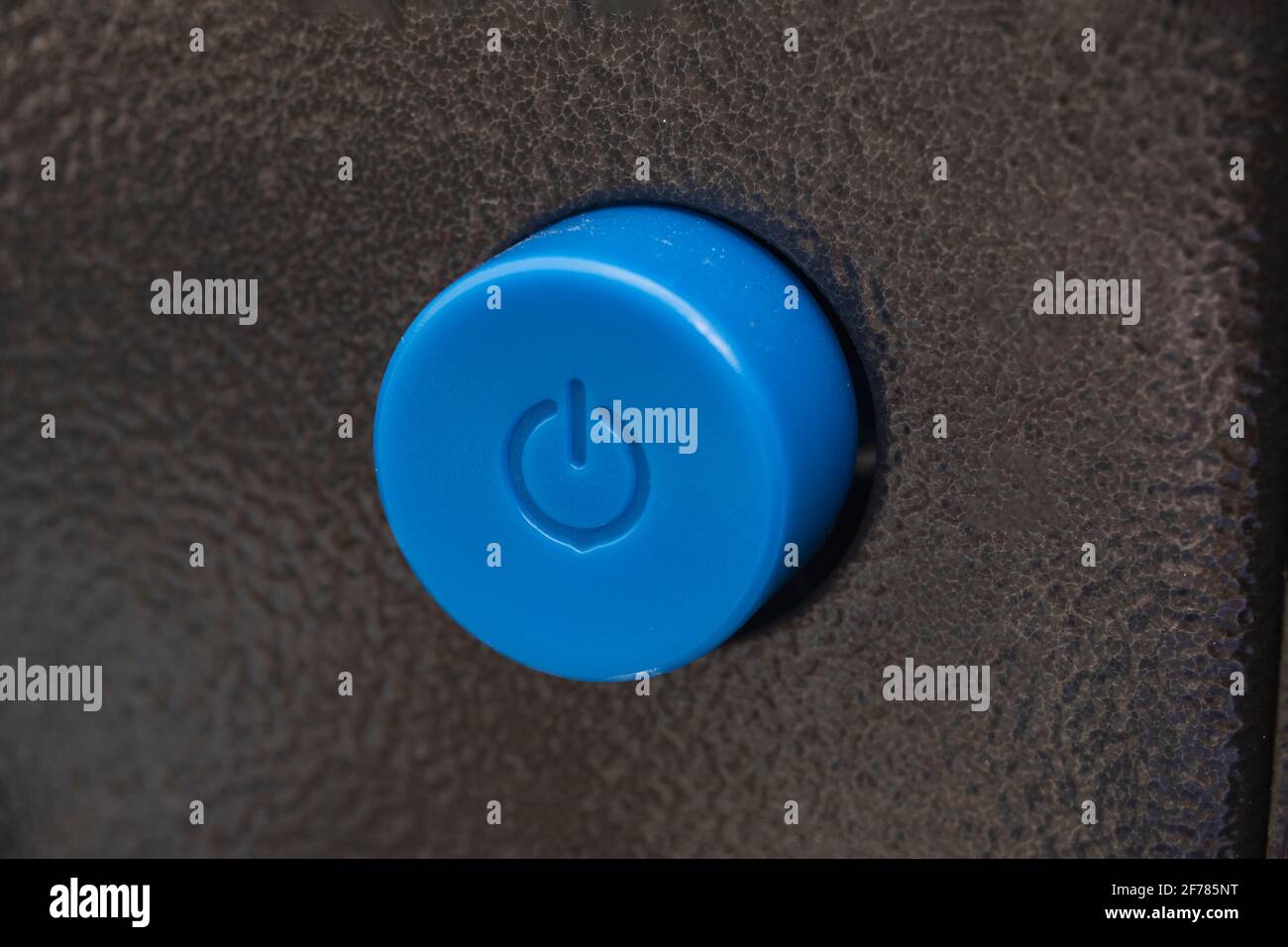 Blue power button on an electronic device close up Stock Photo - Alamy