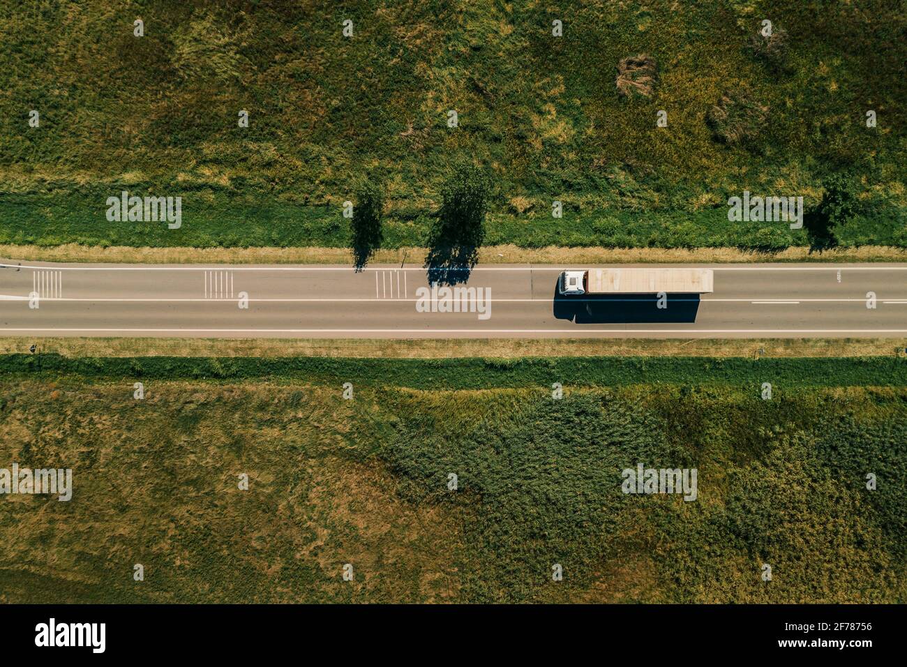 Large freight transporter semi-truck on the road, aerial view top down ...