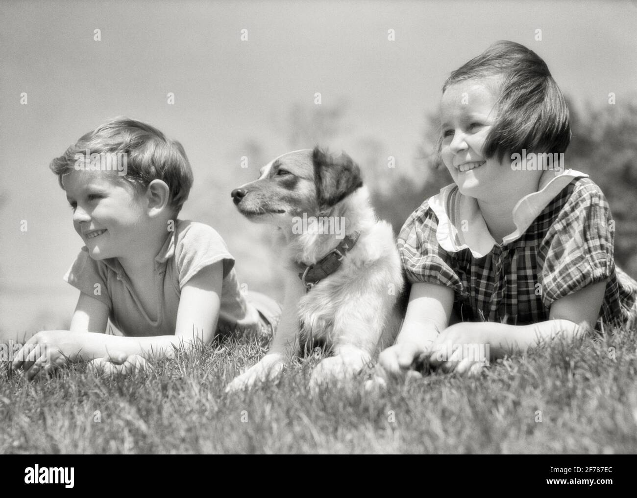 1930s SMILING BOY AND GIRL A BROTHER AND SISTER LYING TOGETHER IN THE ...