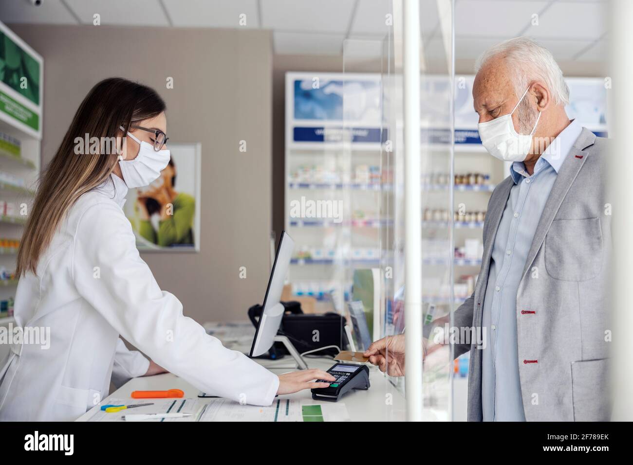 Making a prescription in a pharmacy and paying the bill with a card ...