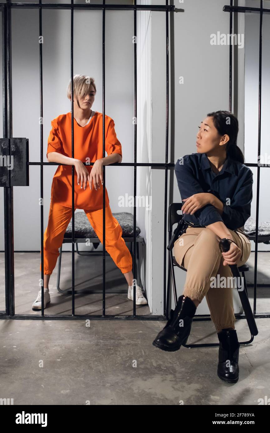 A young criminal and her female guard pose for a photo in prison Stock ...