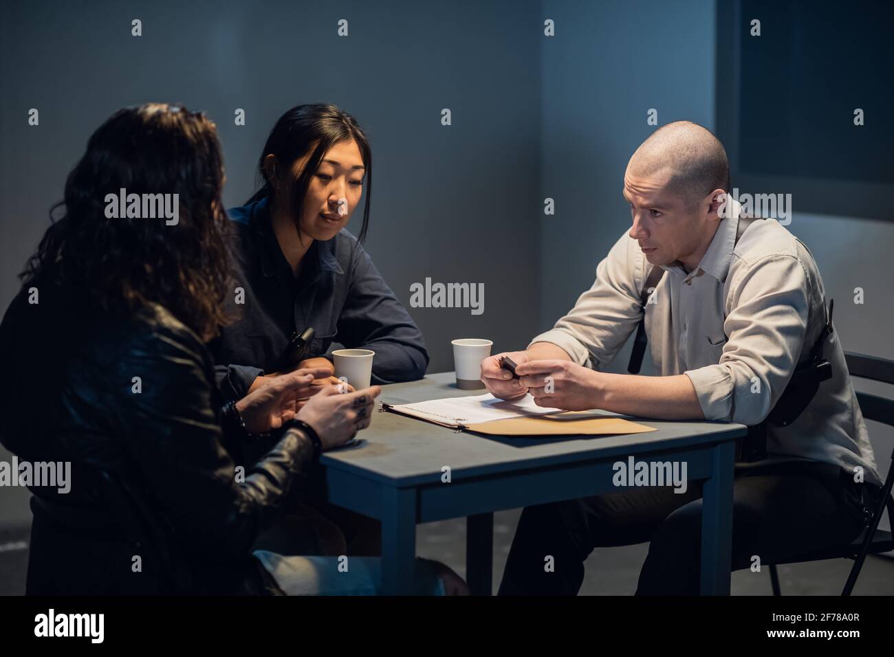 At the police station, two officers are interrogating the captured ...
