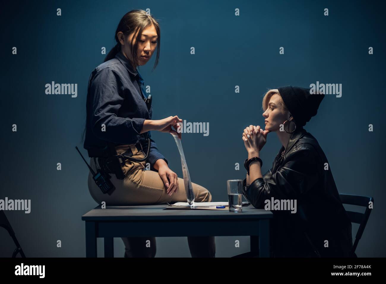 Caught blonde criminal investigator shows evidence in the form of a ...