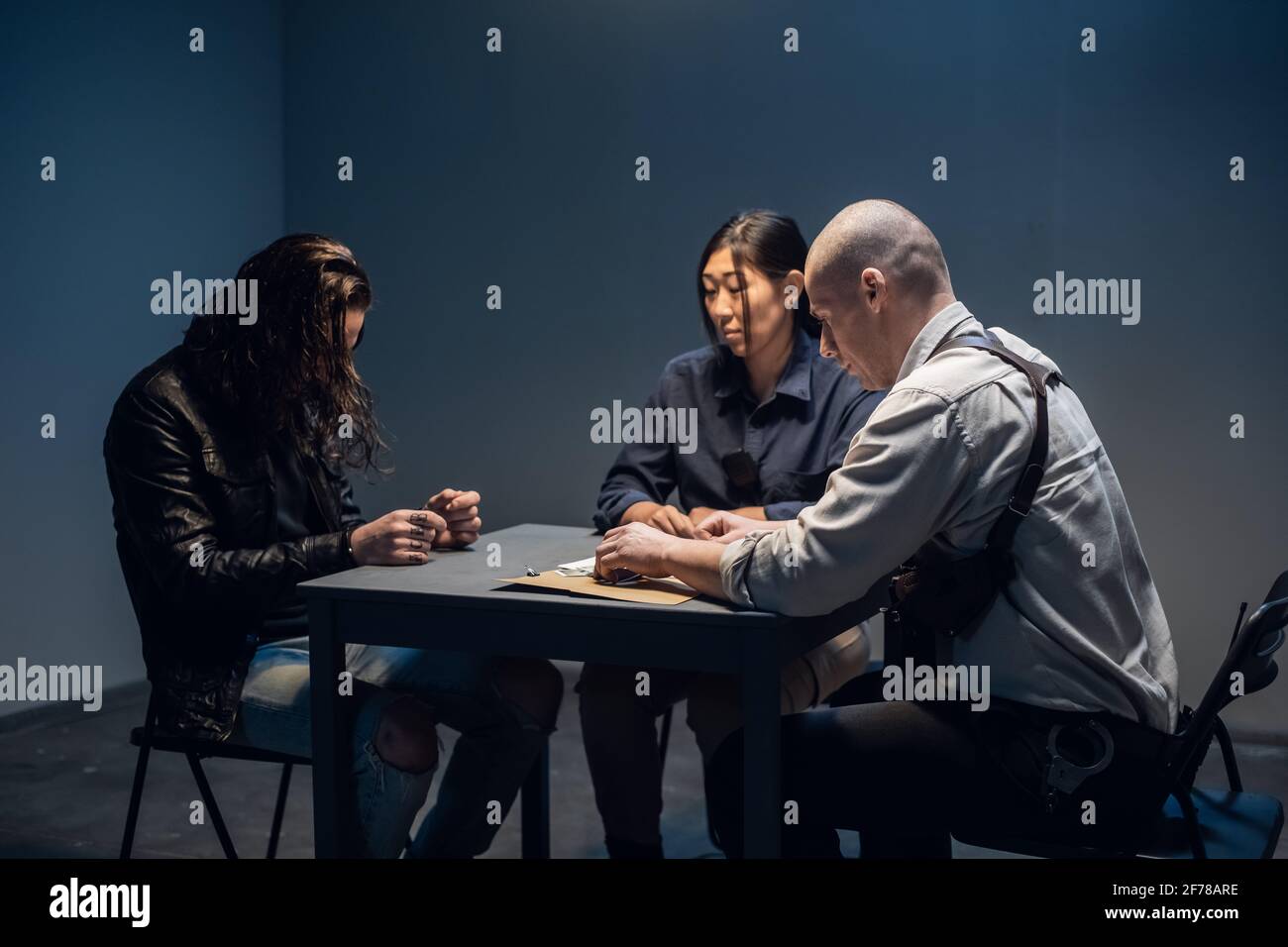 The murder suspect is in the interrogation room with a grim ...
