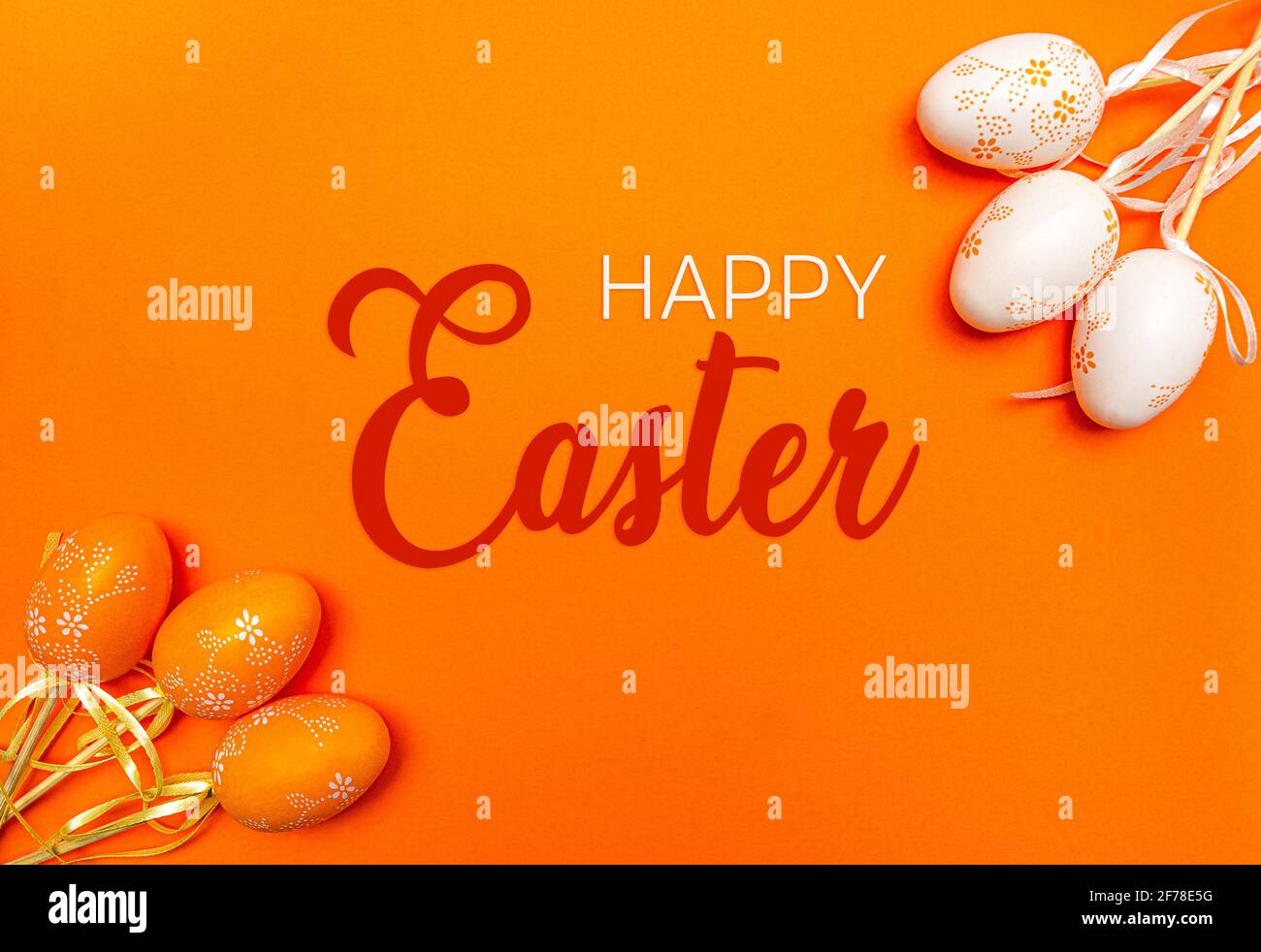 Orange and white Easter eggs on orange background with happy Easter ...