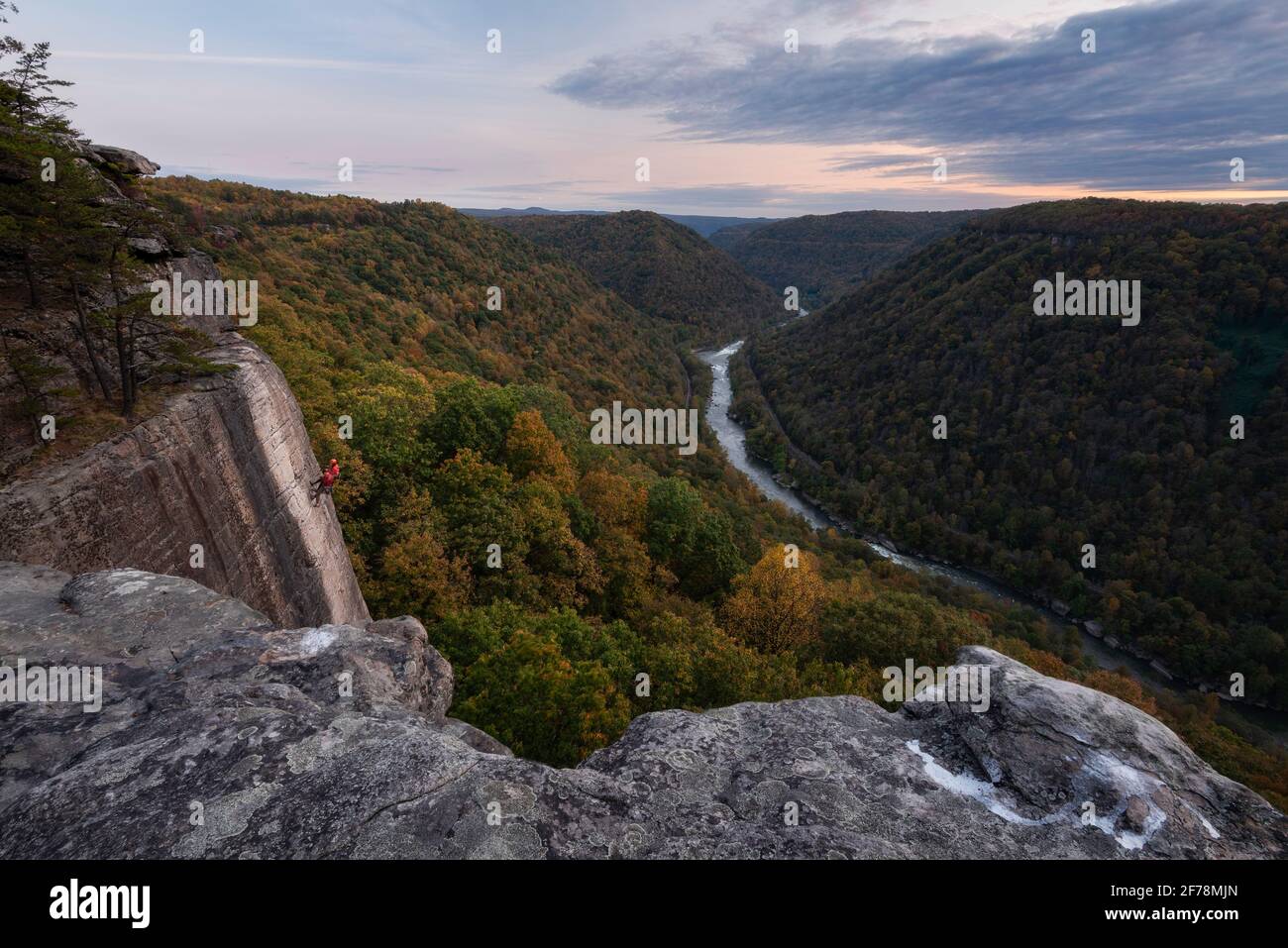 A pair of climbers simul rappelling down into the New River Gorge on a ...