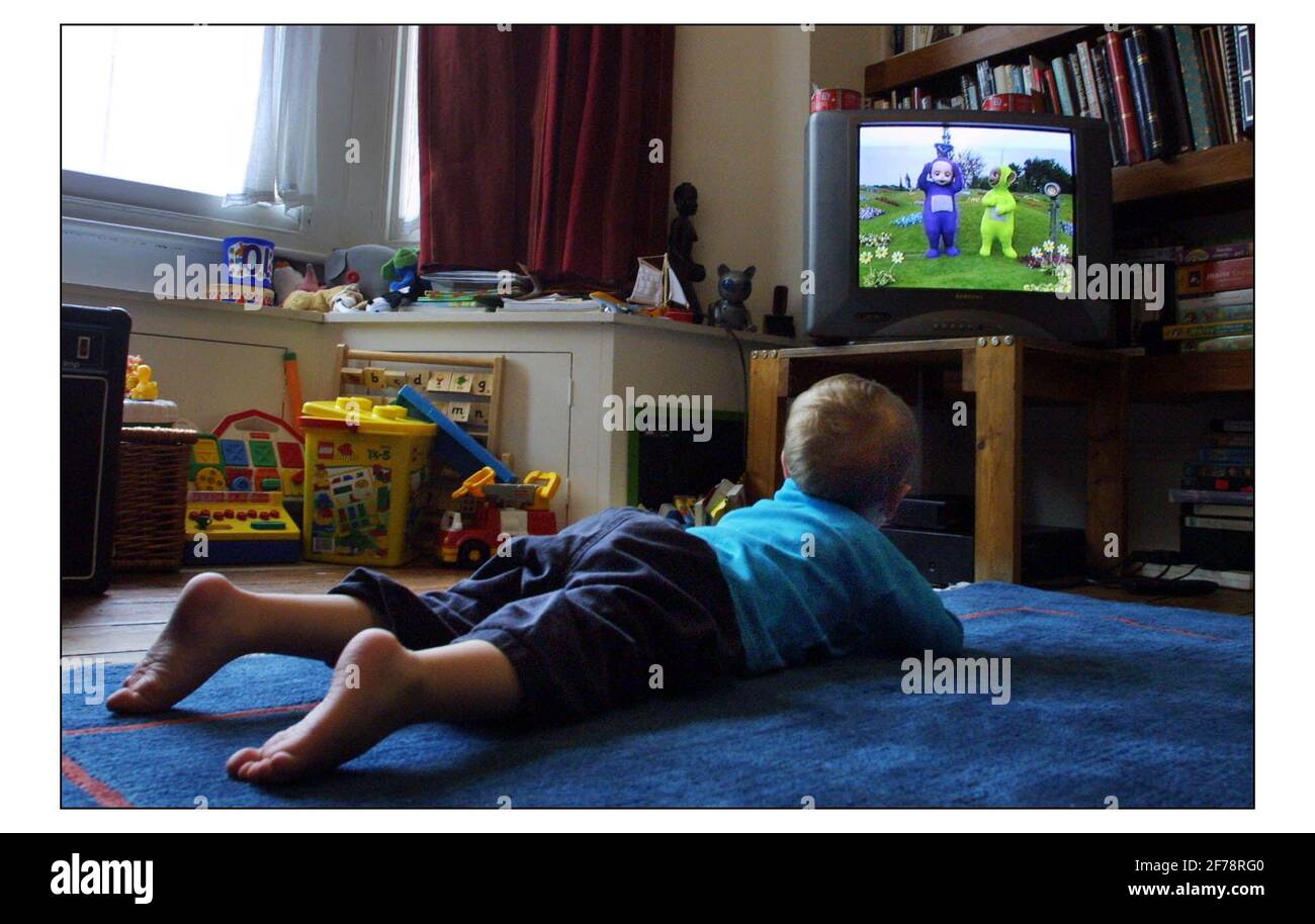 Oliver Bennett watching Tv with his son Bruno.pic David Sandison 30/10 ...