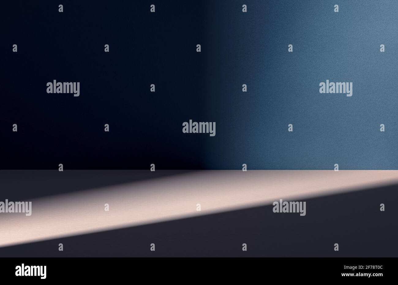 Light color base and blue wall lit by spotlight as place for displaying ...