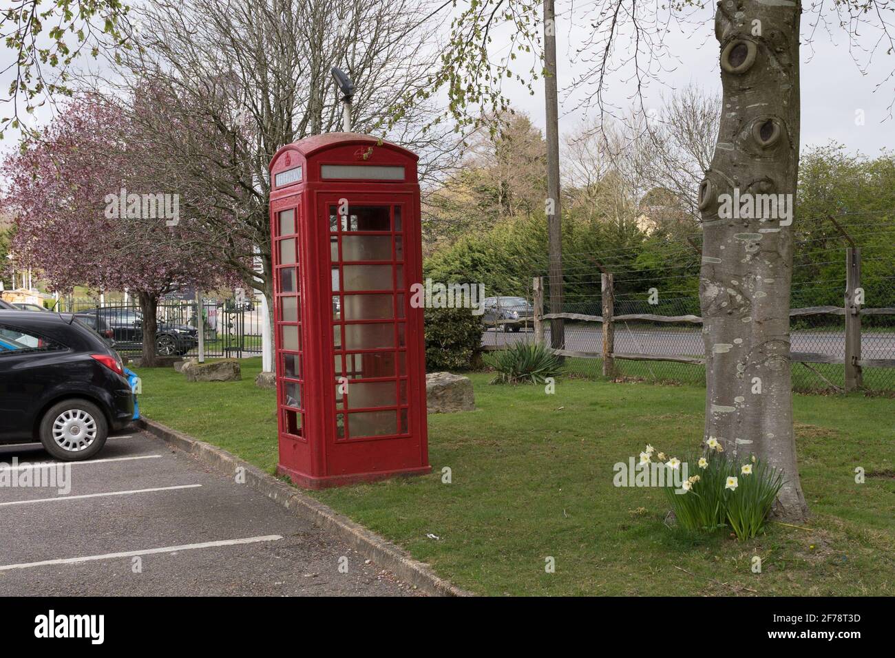 disconnected telephone box stands on lawn next to parking bay Stock ...