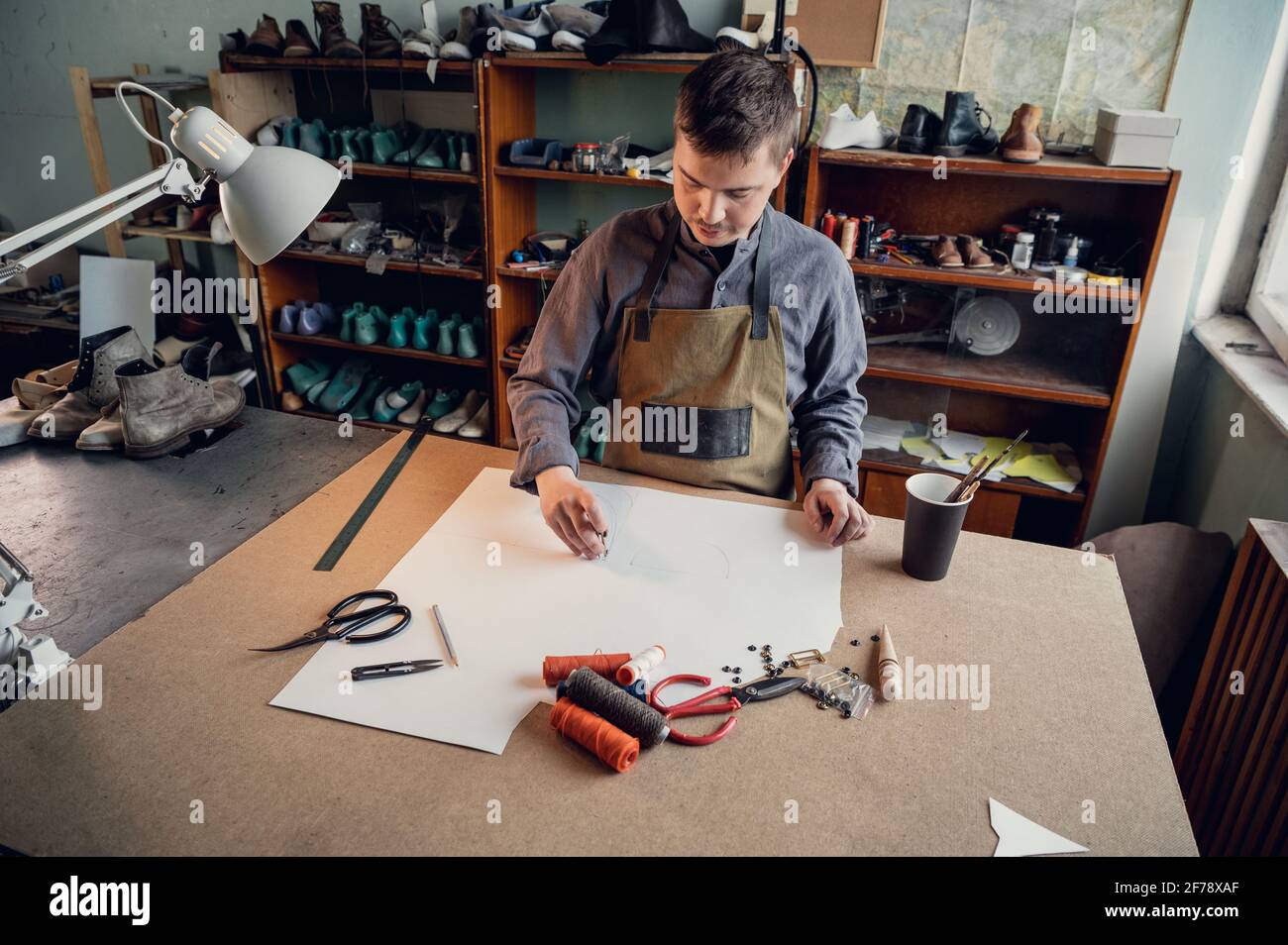 Manual production of shoes in the workshop the shoemaker begins with ...
