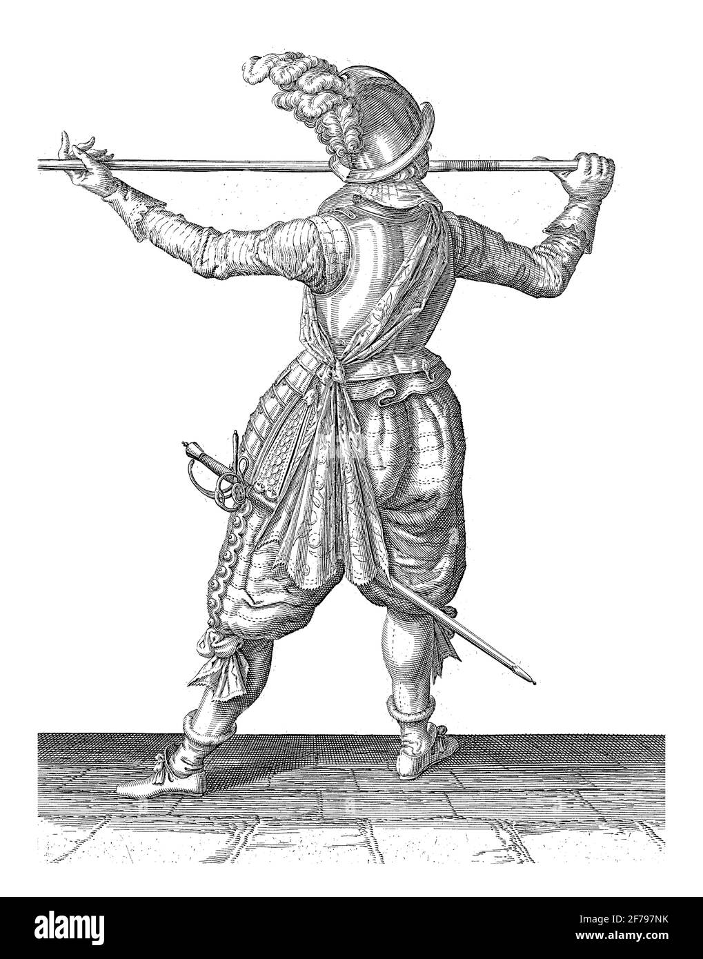 A soldier, seen from the back, carrying a spear with both hands ...