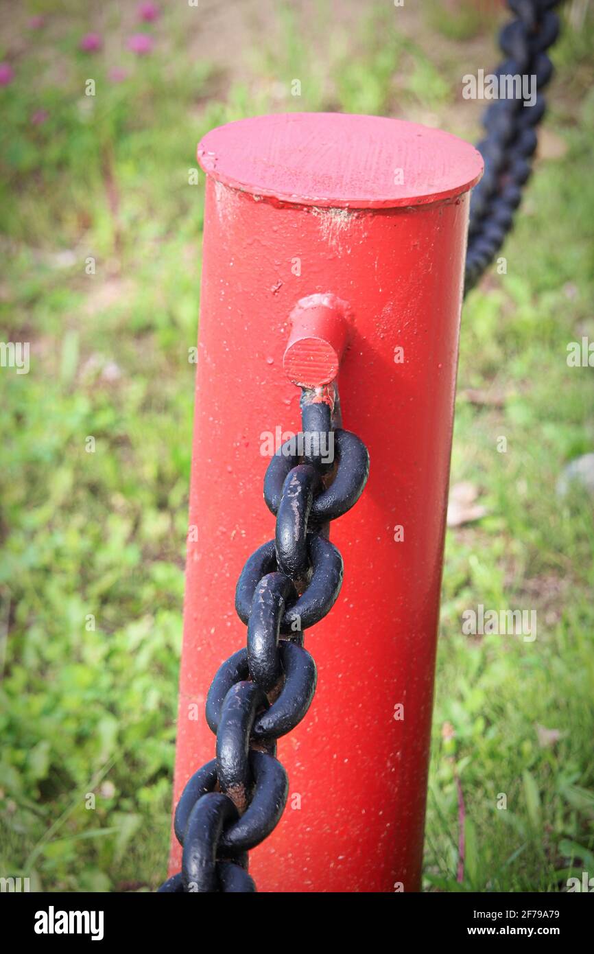 A vertical photo of a red chain link fence Stock Photo - Alamy
