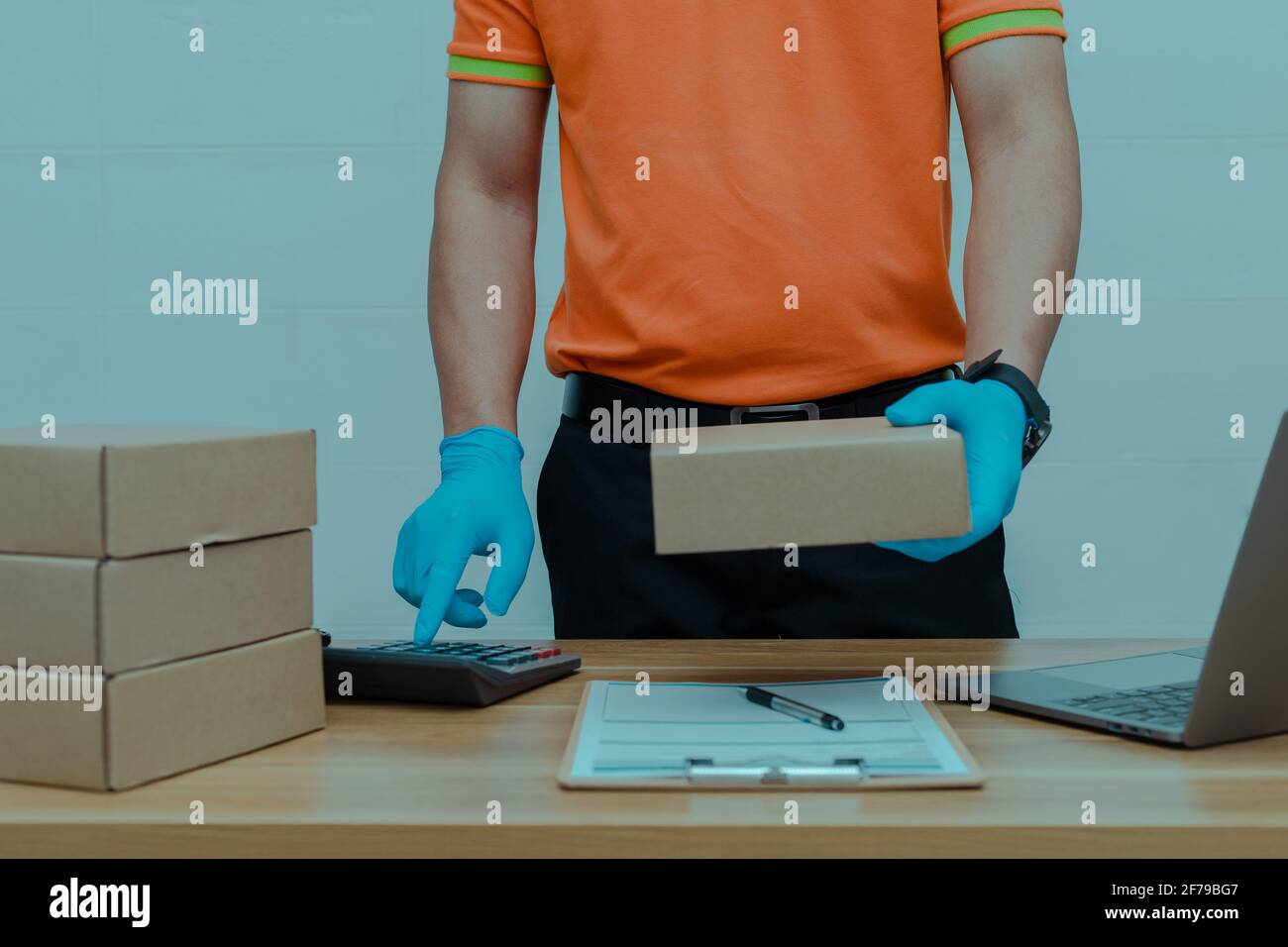 A parcel delivery worker counting the parcel boxes Stock Photo - Alamy