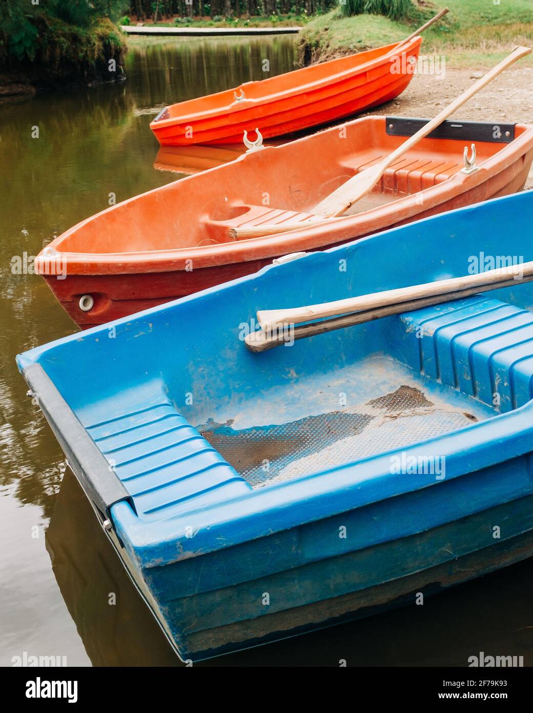 small color boats with paddles on the lake shore Stock Photo - Alamy