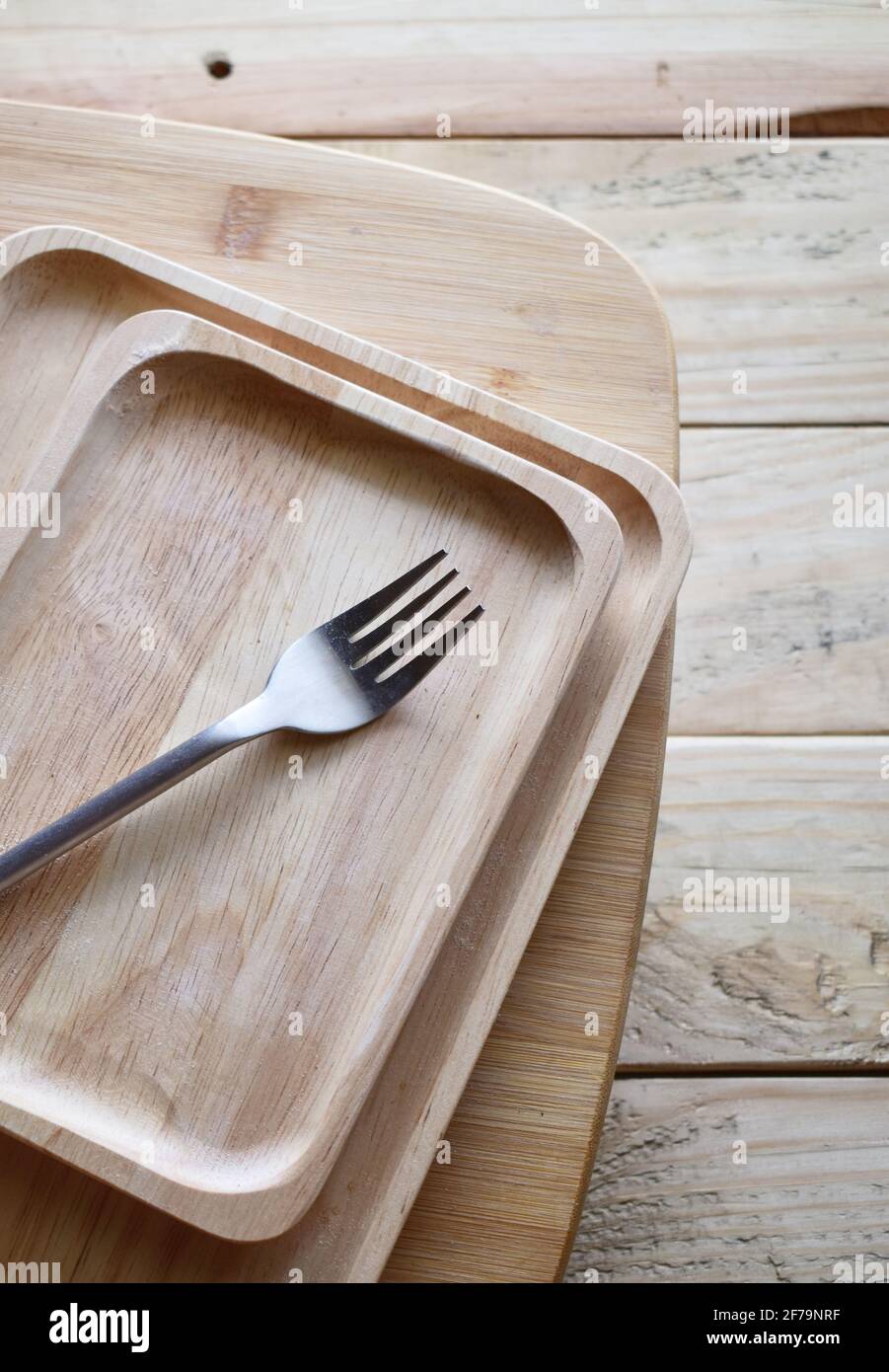 Wooden tray and fork Stock Photo - Alamy