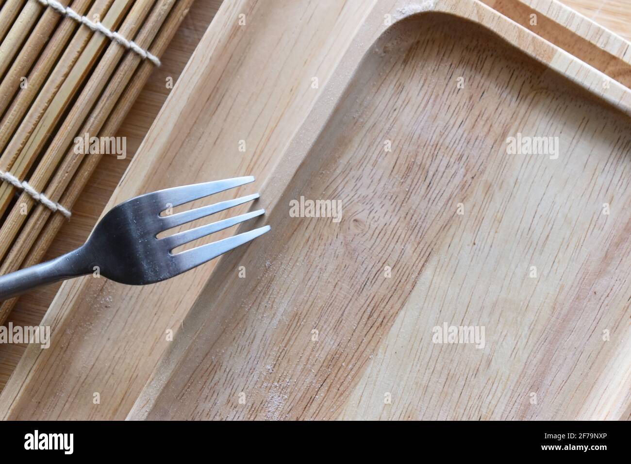 Wooden tray and fork Stock Photo - Alamy