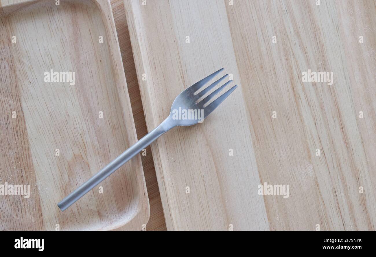 Wooden tray and fork Stock Photo - Alamy
