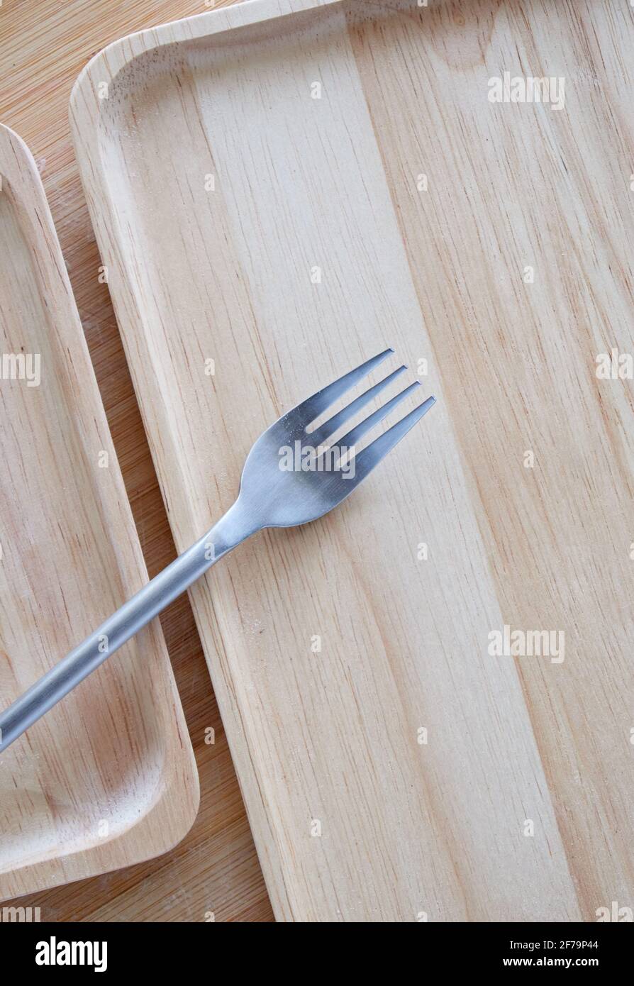 Wooden tray and fork Stock Photo - Alamy