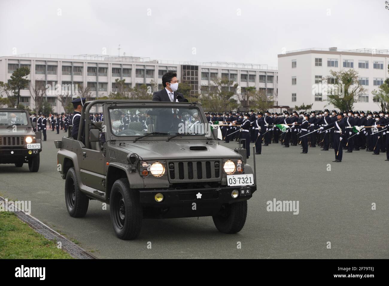 Japanese vice-minister of defense Yasuhide Nakayama drives by students ...