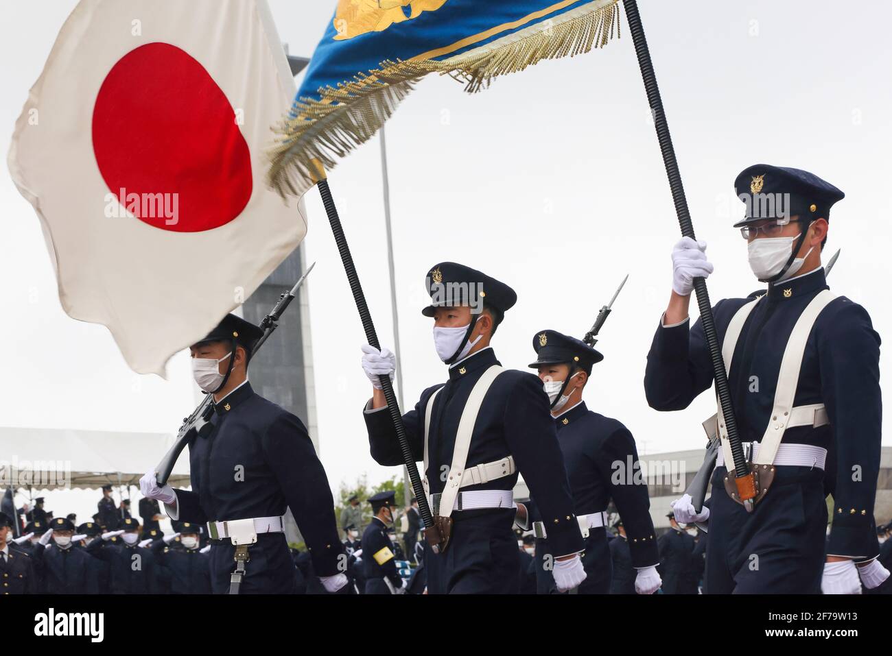 Students of the National Defense Academy hold the Japanese flag ...