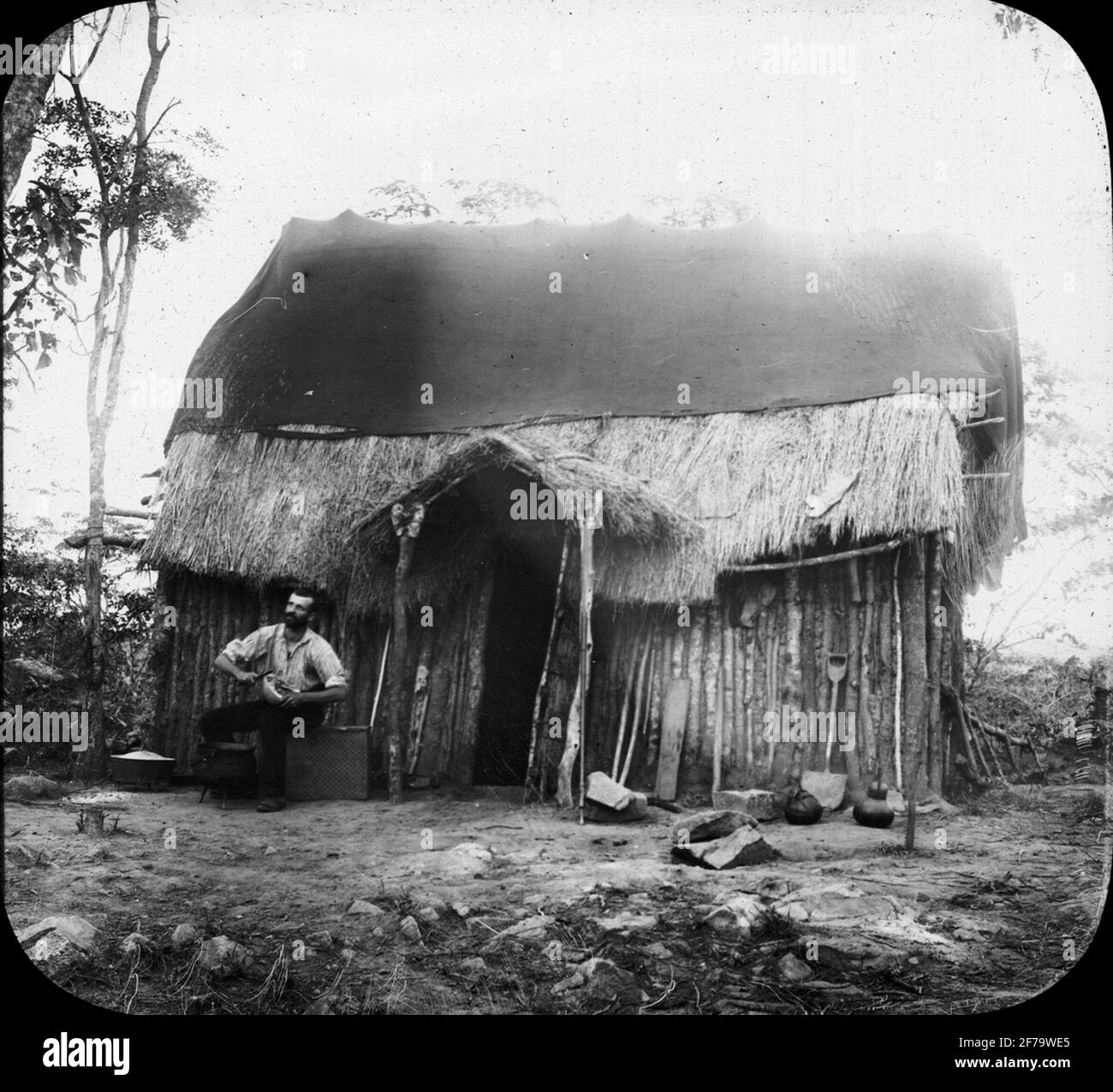 Light image, photography of man outside hut Stock Photo - Alamy