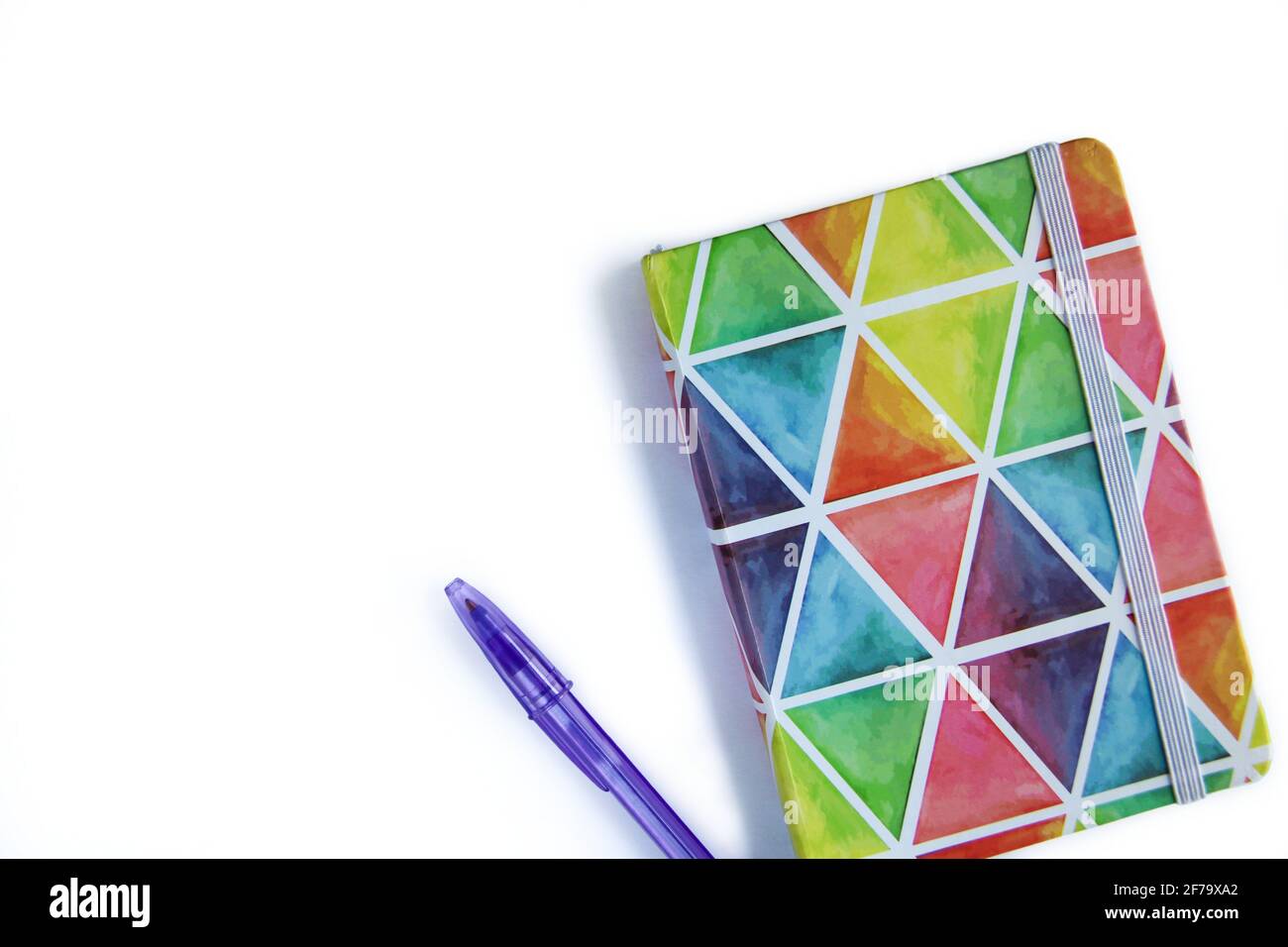 Colorful rainbow notebook with pen on white background. Rainbow colors ...