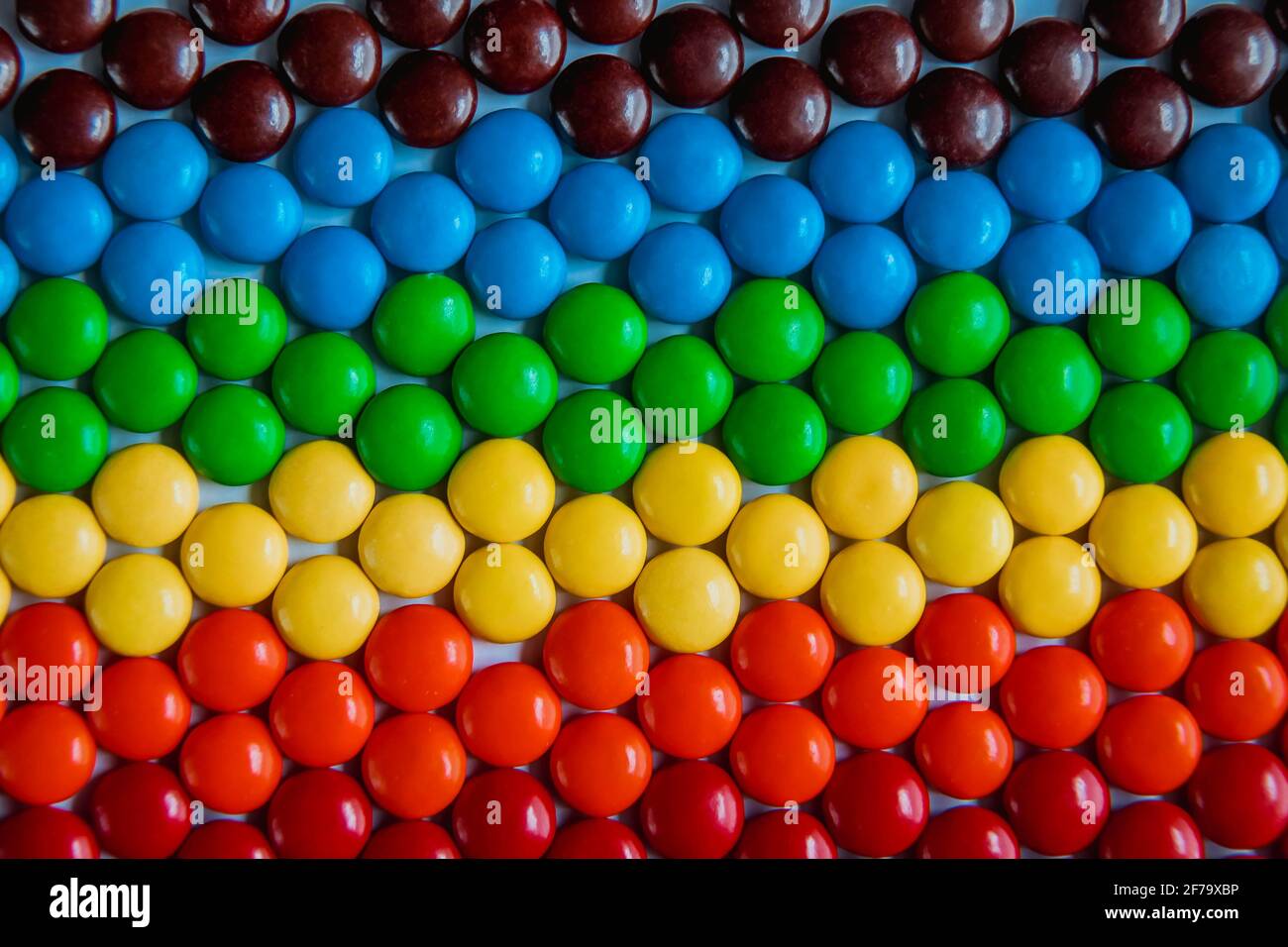 Brightly colored sweet candies laying flat. Rainbow candy background ...