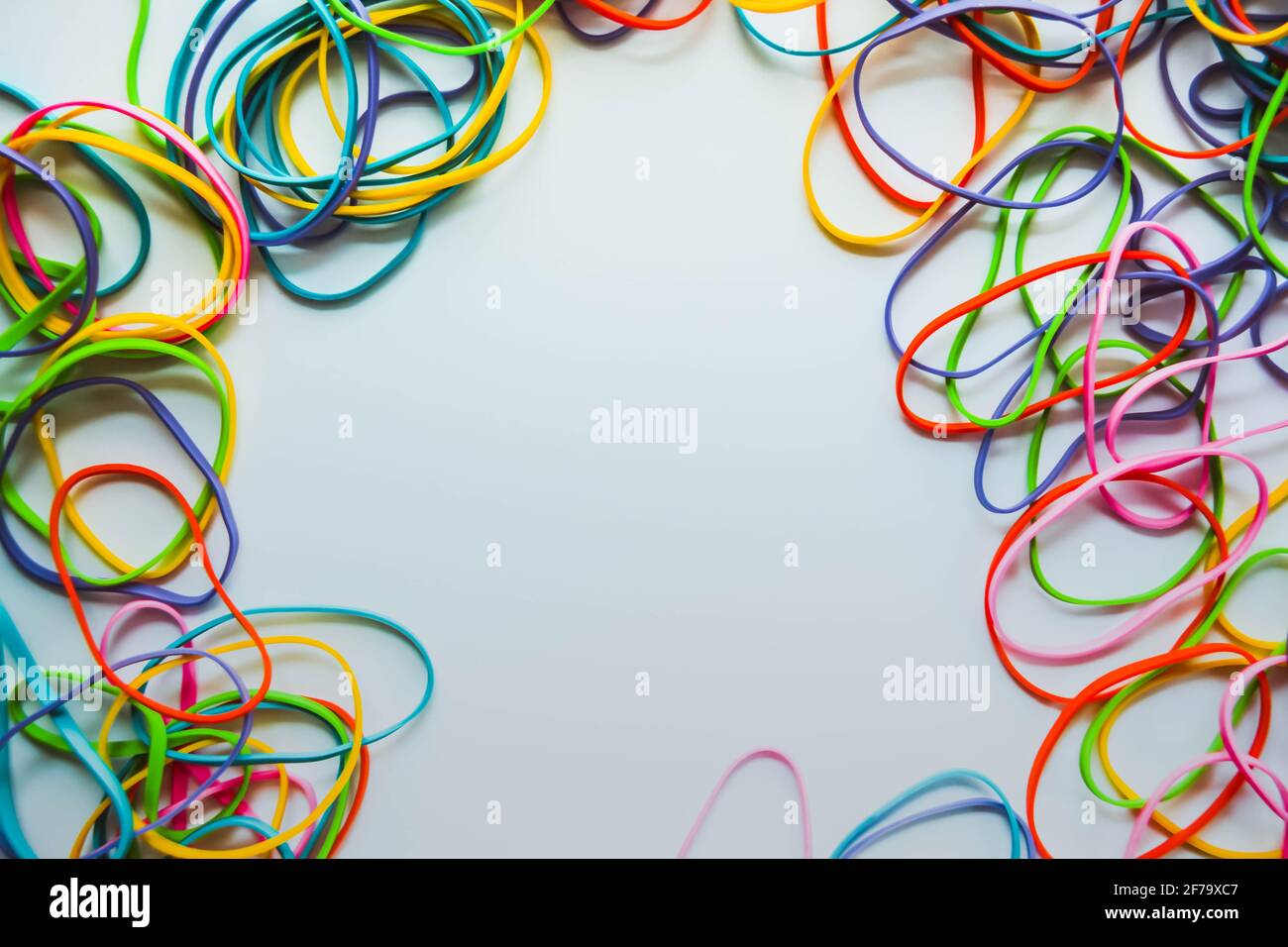 Top view of colorful rubber bands isolated on white. Rainbow elastic ...