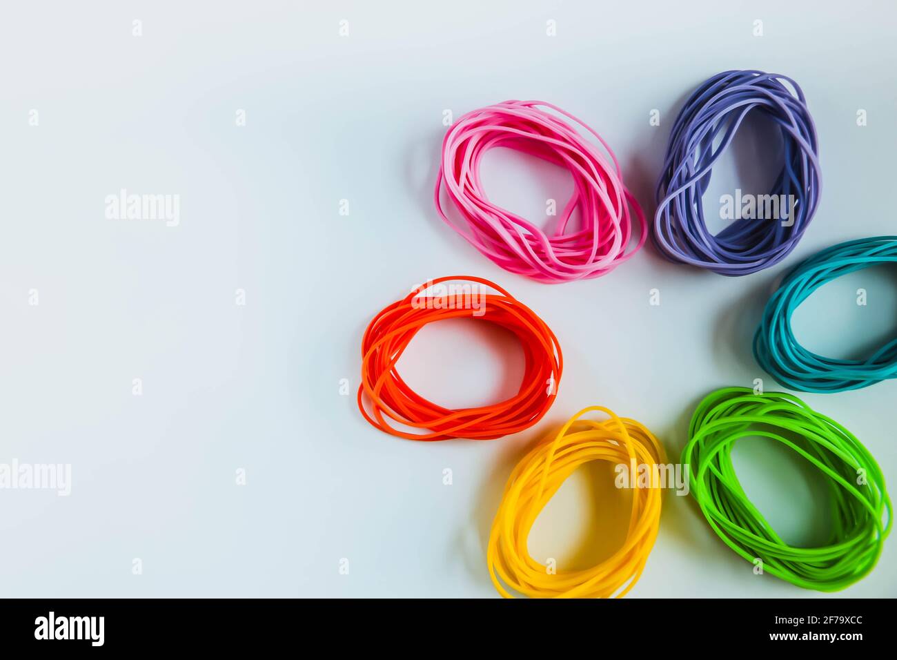 Top view of colorful rubber bands isolated on white. Rainbow elastic ...