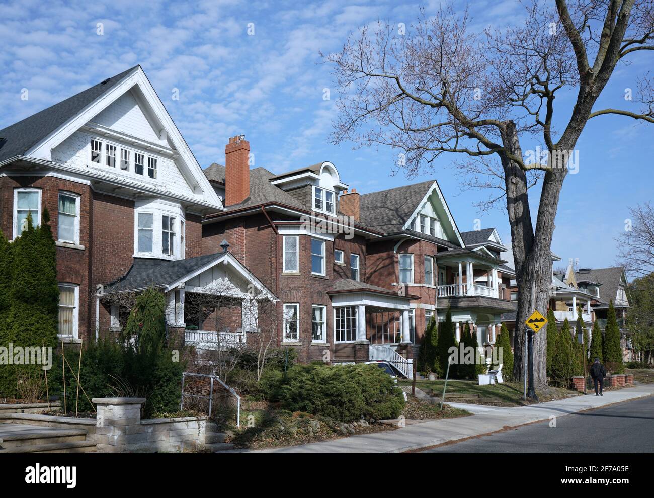 Street with row of large older brick detached houses with gables Stock ...