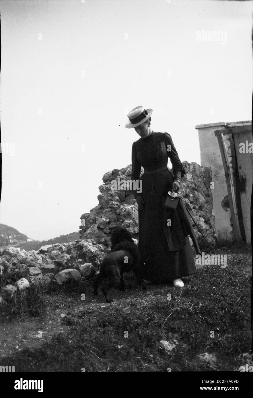 Queen Victoria's pictures. Woman out with camera and dog. Possibly ...