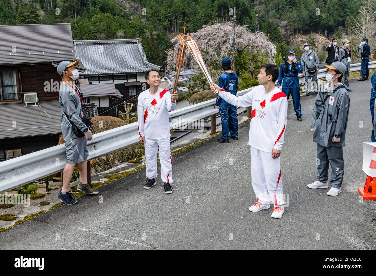 Local torchbearers pass the Olympic flame at Tsumago-juku area during ...