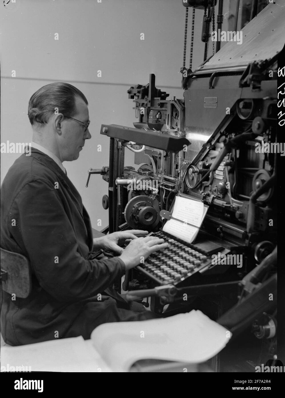 Picture of man at typewriter / printer in factory environment Stock ...