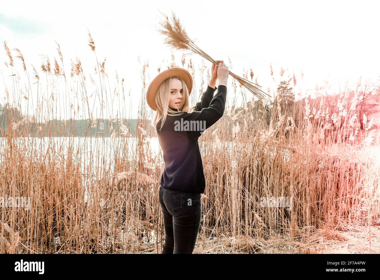 European blonde woman with beige hat in black sweater in the ...