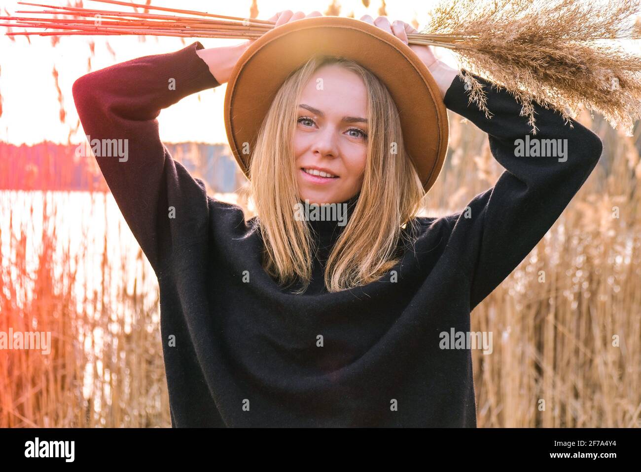 European blonde woman with beige hat in black sweater in the ...