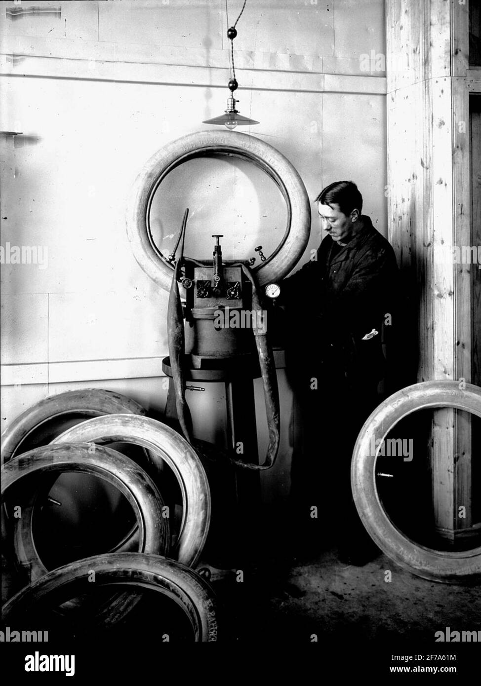 Interior from Gustaf LM Ericsson's Automobil factory. Worker Pumps car ...