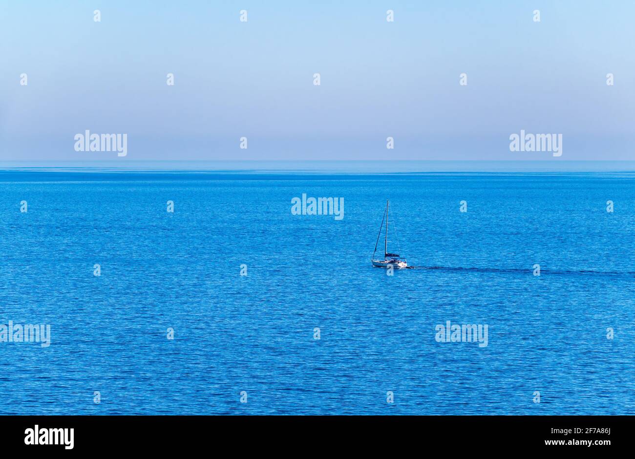 Sailing yacht in the blue calm sea. A yacht in peaceful waters Stock ...