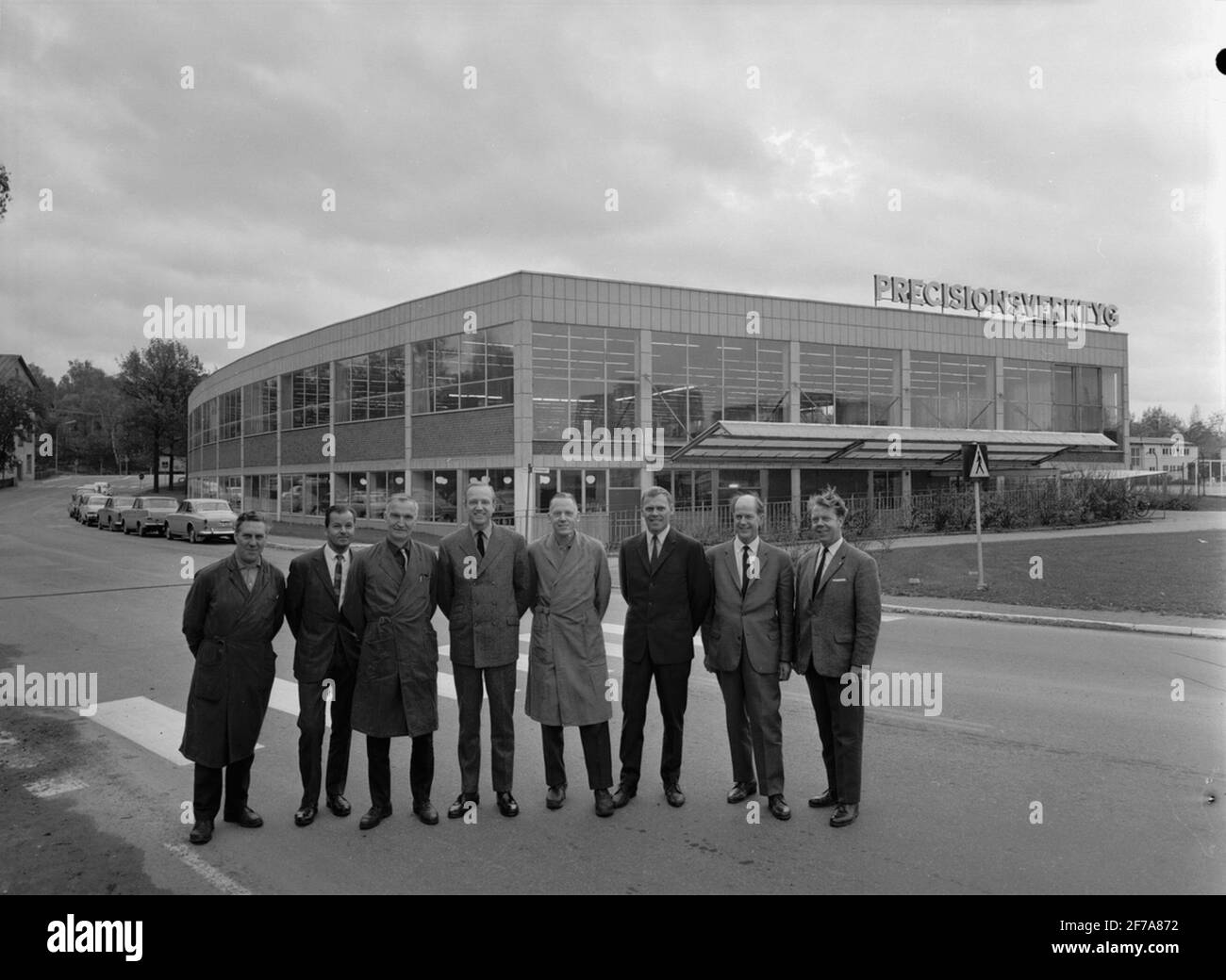 Group in front of factory building. >> Stock Photo - Alamy