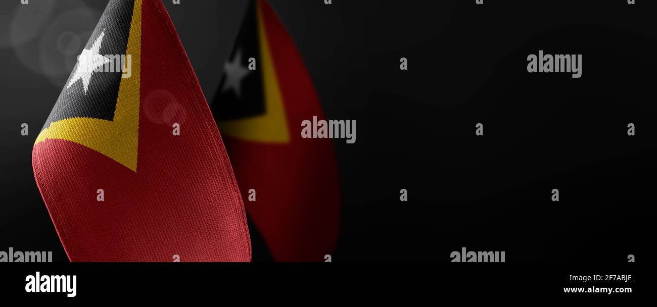 Small national flags of the East Timor on a dark background Stock Photo ...