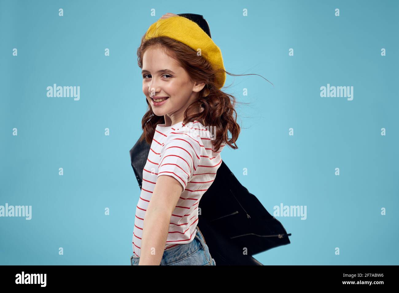 Cheerful cute girl in yellow hat clothes studio blue background Stock ...