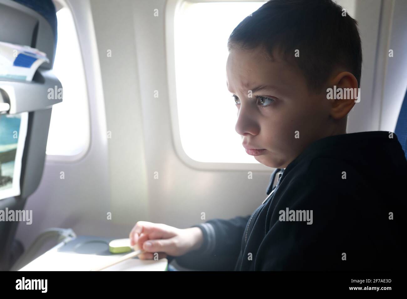 Portrait of sad child on the airplane Stock Photo - Alamy