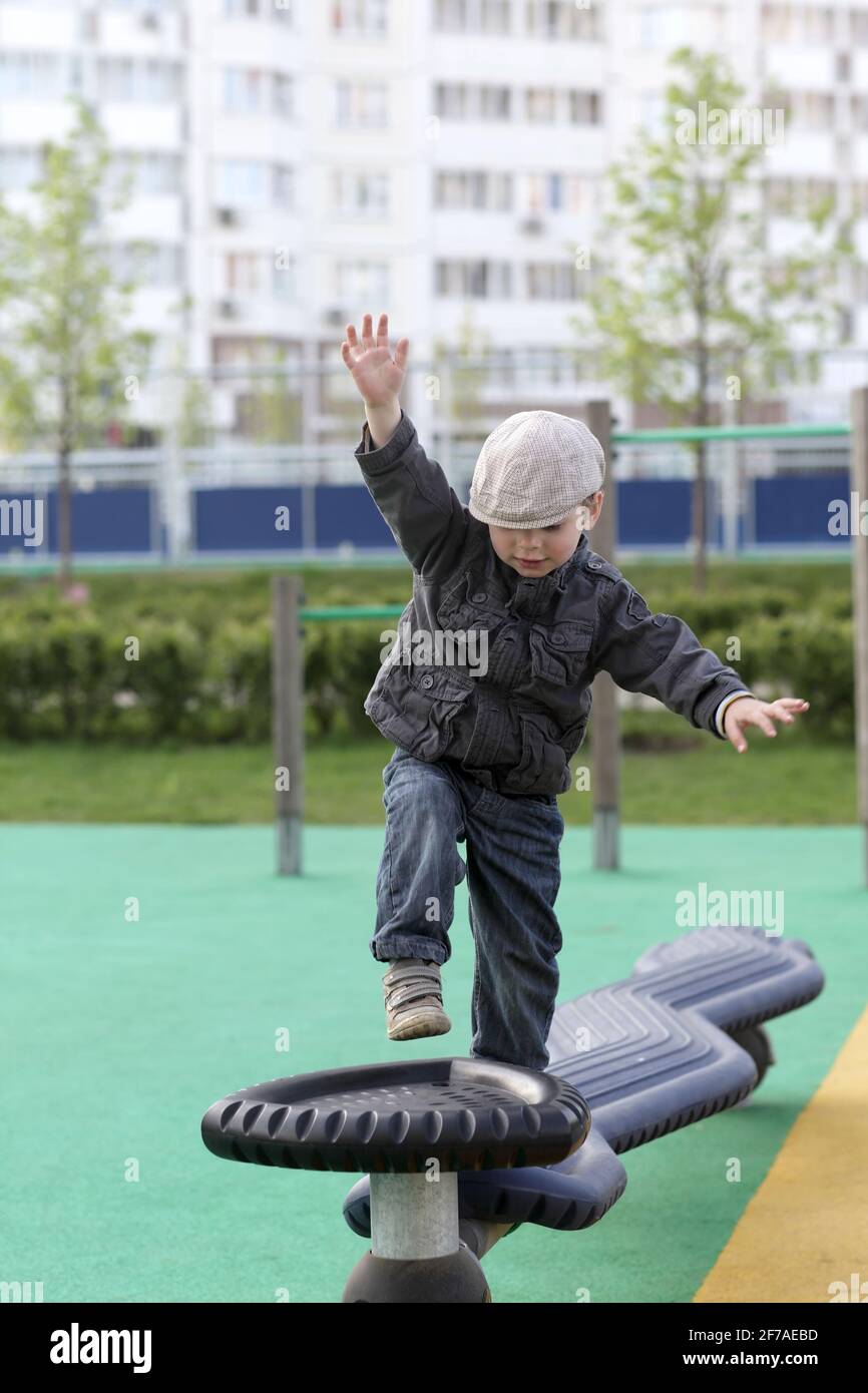 Boy balancing on a sports equipment at outdoor playground Stock Photo ...