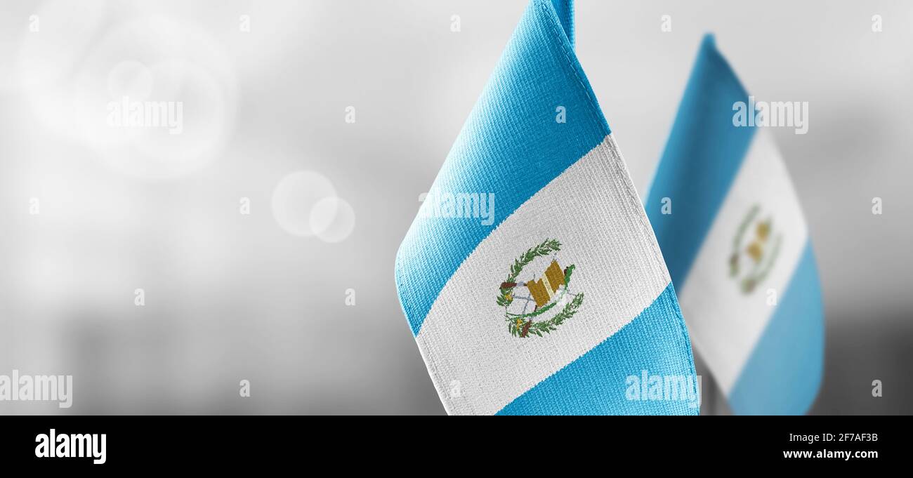Small national flags of the Guatemala on a light blurry background ...