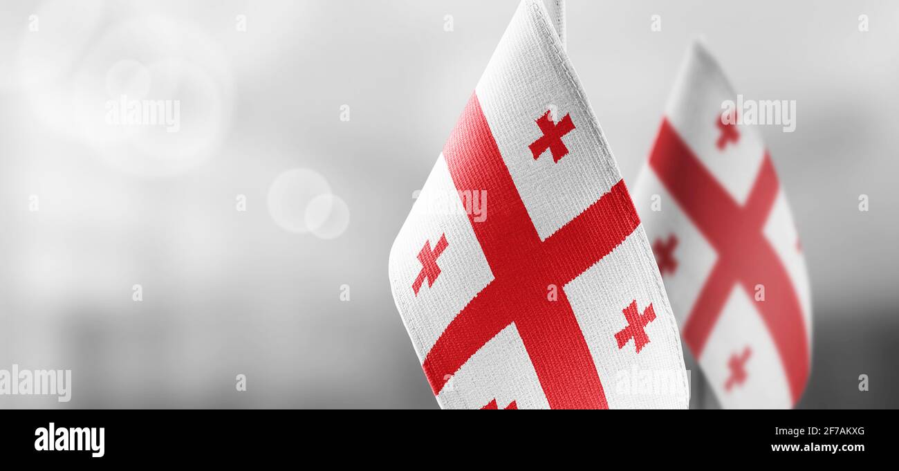 Small national flags of the Georgia on a light blurry background Stock ...