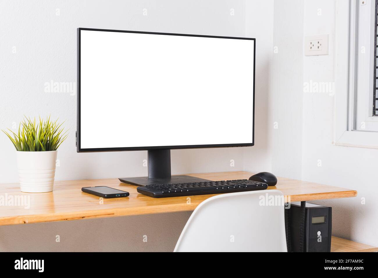 Computer monitor with white blank screen on the business desk with ...