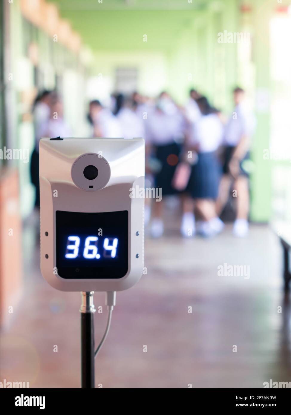 Temperature digital thermometer in school with students for scan ...